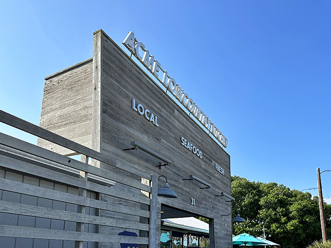 The weathered wooden facade isn't just rustic charm&mdash;it's a promise of authenticity. LOCAL. SEAFOOD. FRESH. Three words that sum up the Acme experience perfectly.