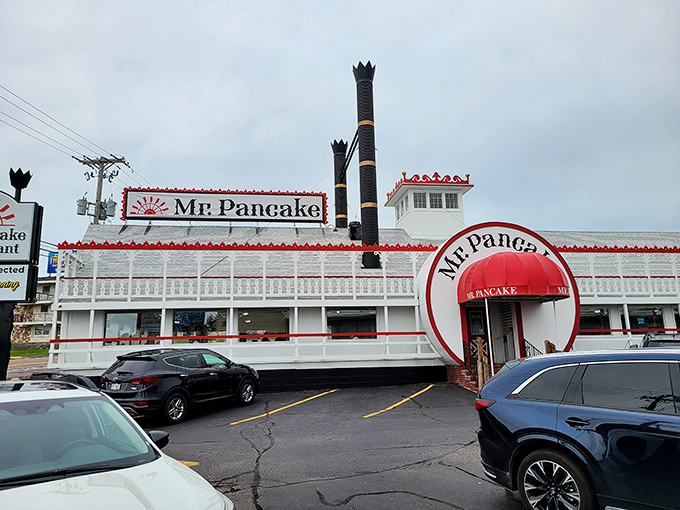 The iconic red windmill of Mr. Pancake stands like a breakfast lighthouse on Wisconsin Dells' main strip, beckoning hungry travelers to pancake paradise.