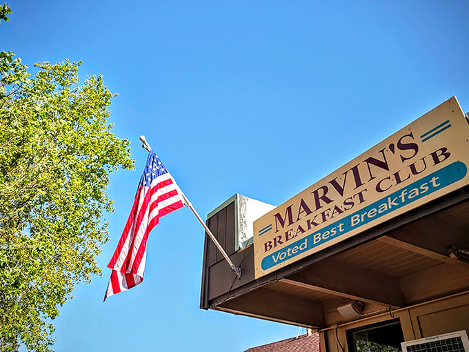 The American flag waves proudly above Marvin's Breakfast Club, a humble storefront that's earned its "Voted Best Breakfast" badge through years of morning meal mastery.