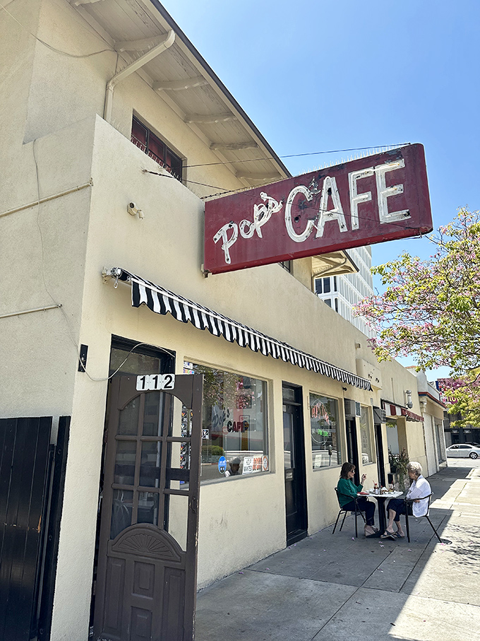 The unassuming yellow exterior of Pop's Cafe stands as a beacon of breakfast hope in Santa Ana, where California sunshine meets classic American diner charm.