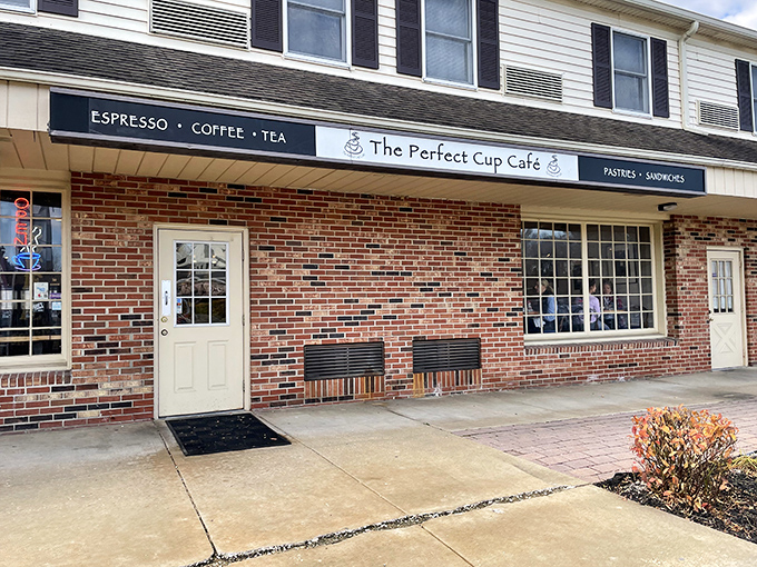 The Perfect Cup Cafe's charming storefront promises caffeinated delights and homemade treats behind its unassuming brick facade. Simplicity at its finest.
