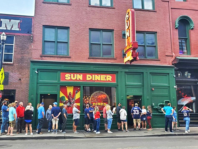 The emerald-green storefront of Sun Diner pops against Nashville's brick backdrop, its rooster logo promising both musical nostalgia and breakfast bliss on 3rd Avenue.
