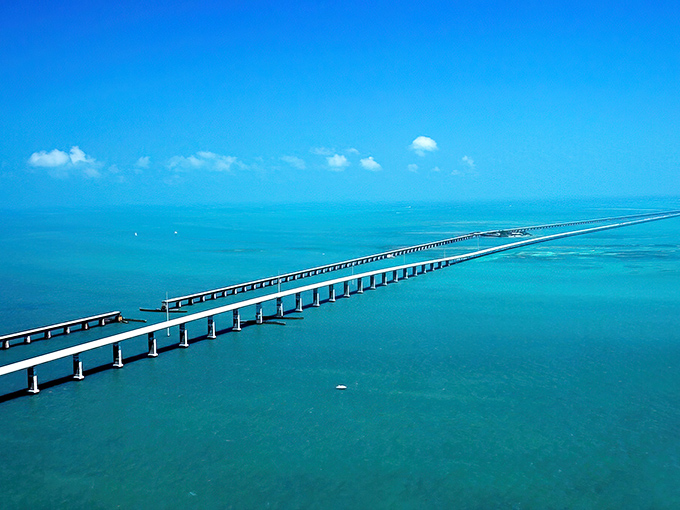 Where the sky meets the sea meets engineering marvel&mdash;the Seven Mile Bridge stretches across impossibly turquoise waters, with Pigeon Key nestled like a green jewel below.
