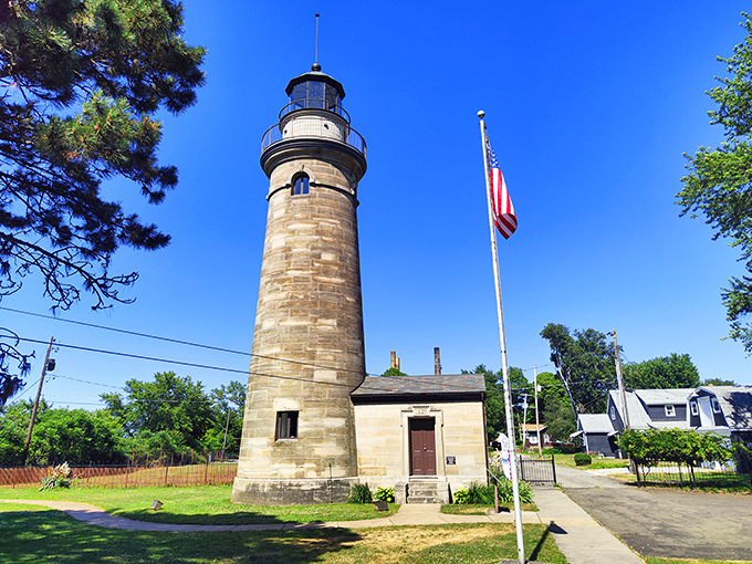 The Erie Land Lighthouse stands majestically against Lake Erie's shimmering waters, a honey-colored sentinel that's been keeping watch since before Instagram was even a concept.