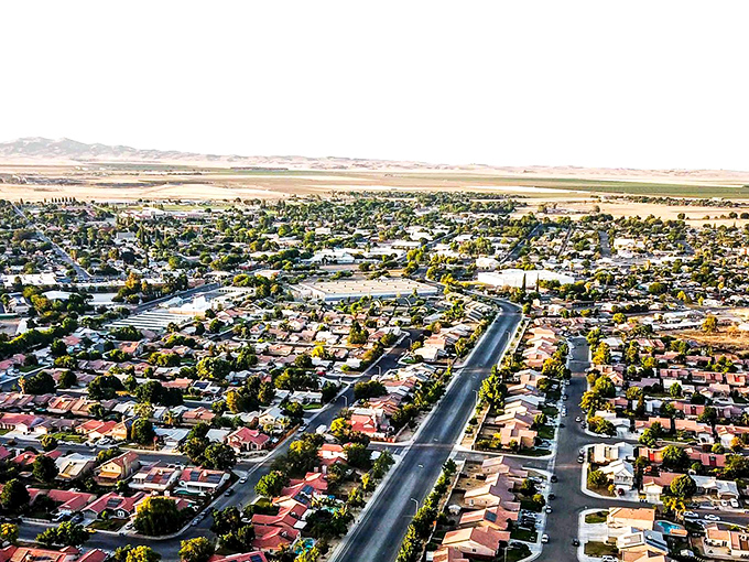 Aerial view of Coalinga reveals a patchwork of terracotta roofs and tree-lined streets, where California sunshine meets small-town charm without the big-city price tag.