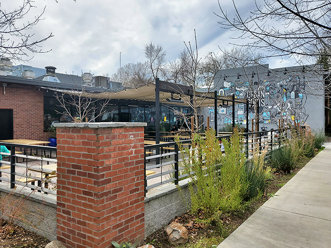 The exterior beckons with brick pillars and a spacious patio, like a modern saloon where smoke signals promise delicious things ahead.