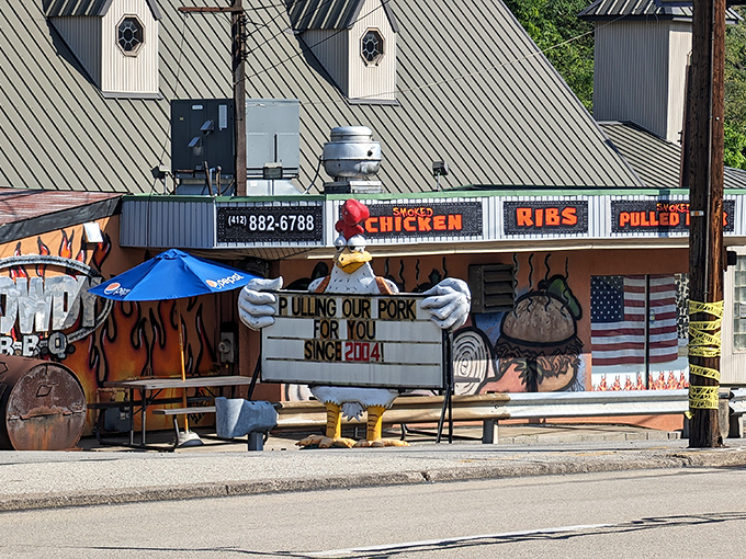 The roadside charm of Rowdy BBQ beckons with its colorful signage and whimsical mascot. Pulling pork since 2004? That's some serious smoking commitment!