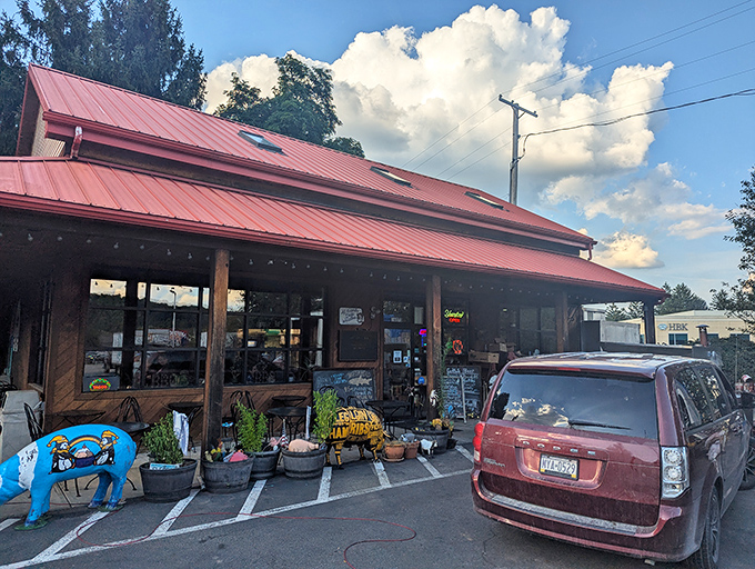 The red-roofed barbecue sanctuary beckons with its rustic charm, complete with a whimsical blue pig statue standing guard at the entrance.