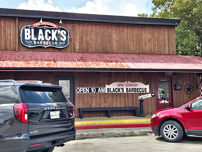 The barbecue beacon of Lockhart stands proud with its weathered wood exterior and iconic red tin roof&mdash;Texas authenticity you can spot from a mile away.