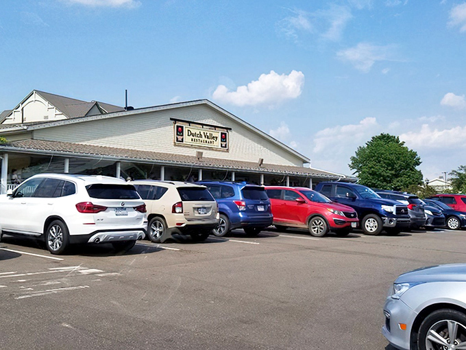 The welcoming yellow exterior of Dutch Valley Restaurant stands like a beacon of comfort food in Sugarcreek's rolling countryside. Those hanging flower baskets aren't just for show!