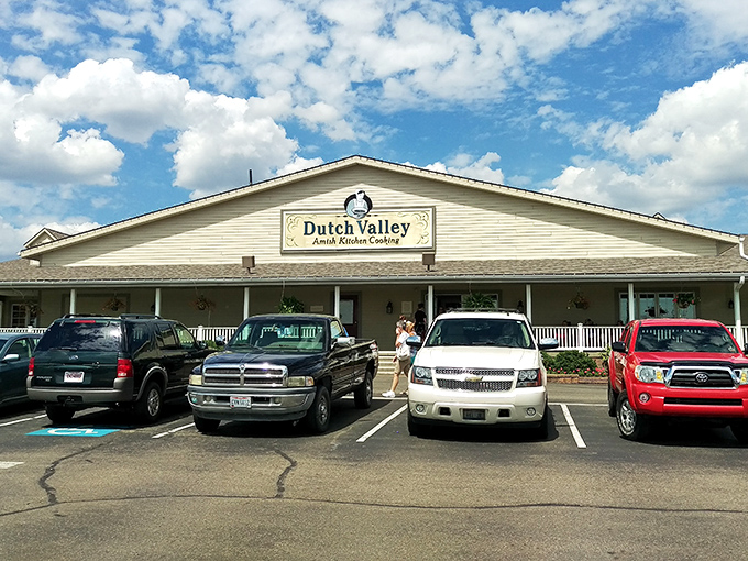 The welcoming yellow exterior of Dutch Valley Bakery stands like a beacon of carb-laden hope in Sugarcreek's rolling countryside.