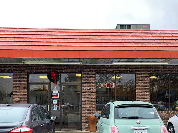 The iconic red-roofed brick exterior of Sunrise Drive-In stands as a beacon of comfort food in Florence, where hungry locals have been finding their way for generations.