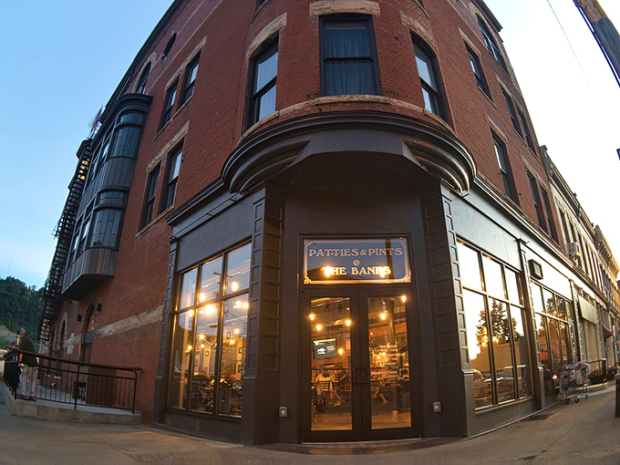As dusk settles, the warm glow from Patties & Pints transforms this historic brick building into a beacon for hungry travelers and locals alike.