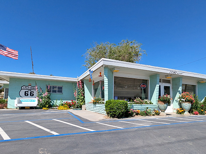 The mint-green facade of Emma Jean's stands like a time capsule on Route 66, welcoming hungry travelers with colorful flower pots and small-town charm.