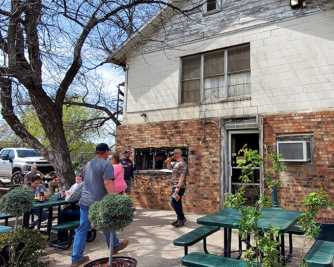 Brick and mortar simplicity with outdoor picnic tables where locals gather, proving that in Texas, the best dining rooms sometimes don't have walls at all.