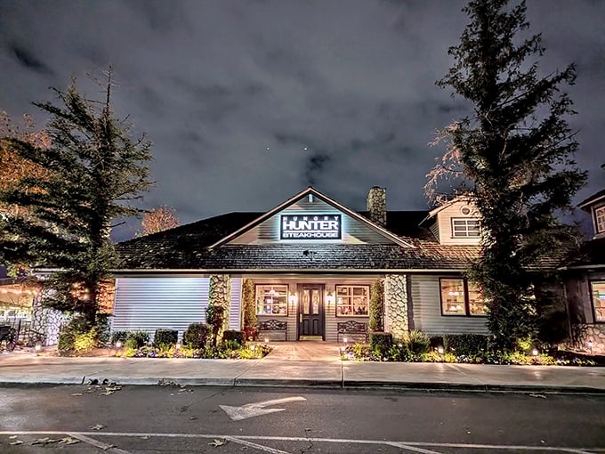 The rustic stone and timber exterior of Hungry Hunter Steakhouse stands like a welcoming mountain lodge, promising carnivorous delights within its cozy walls.