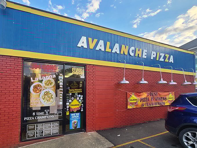 The blue and red exterior of Avalanche Pizza stands out like a superhero's costume – bold, unapologetic, and promising to save you from mediocre meals.