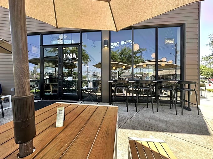 The modern storefront beckons with warm globe lights and a sleek design. Like finding a secret doorway to flavor paradise in suburban Houston.