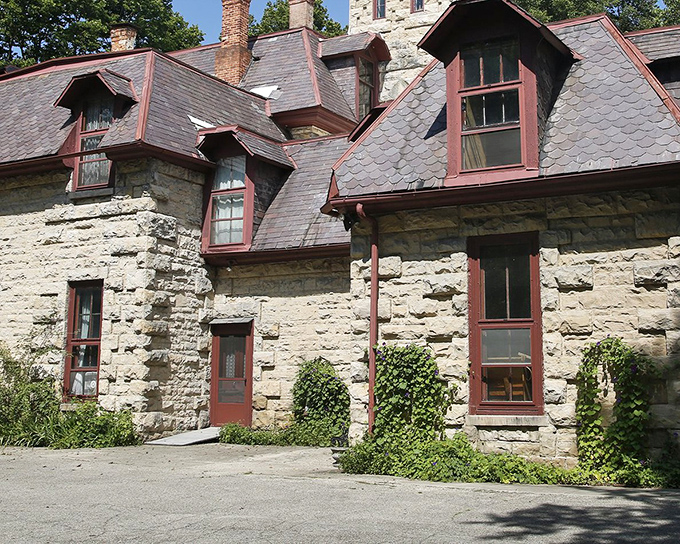 The limestone exterior of Piatt Castle Mac-A-Cheek features distinctive red-trimmed windows and dormers that make you wonder if you've accidentally wandered into a European fairy tale.