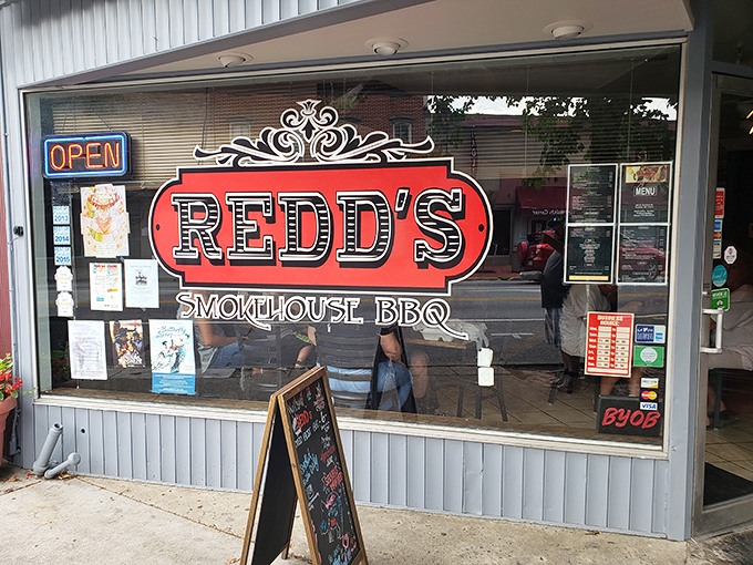 The unassuming blue storefront with its neon "RIBS" and "WINGS" signs promises what every BBQ pilgrim seeks: authentic flavor without pretense.