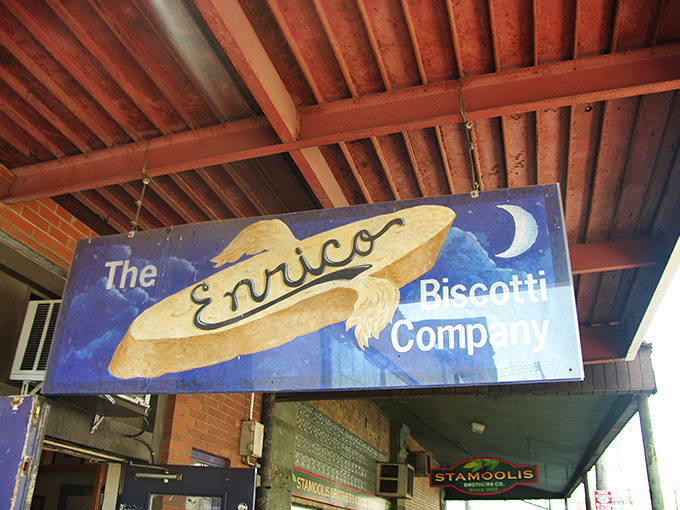 The whimsical blue sign hanging beneath rustic wooden beams welcomes hungry visitors to Pittsburgh's beloved Italian bakery haven.