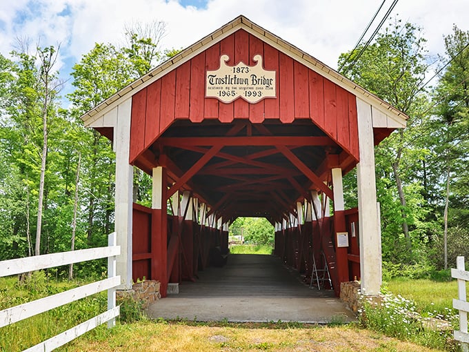 The classic red exterior of Trostletown Covered Bridge stands as a vibrant reminder of Pennsylvania's rich architectural heritage, beckoning travelers to step back in time.