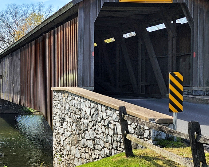 The stone abutments and weathered wood create a scene straight out of a Thomas Kinkade painting, minus the excessive glowing windows.