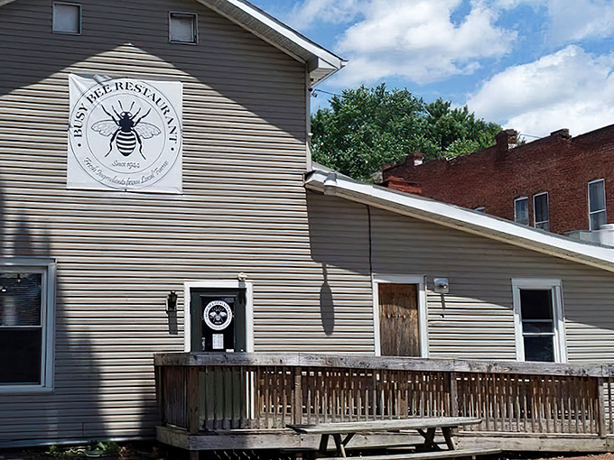 The unassuming exterior of Busy Bee Restaurant, where that iconic bee logo promises something sweet awaits inside this Marietta gem. 