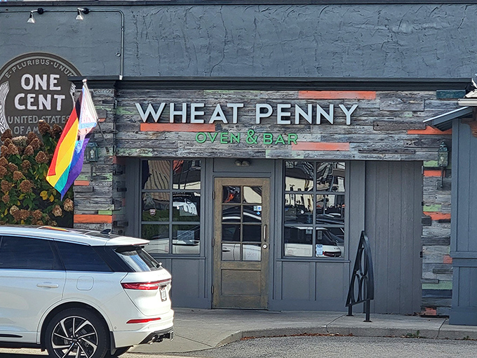 The iconic Wheat Penny exterior welcomes you with colorful reclaimed wood, lush hydrangeas, and a pride flag that says "everyone's welcome at this Dayton gem."