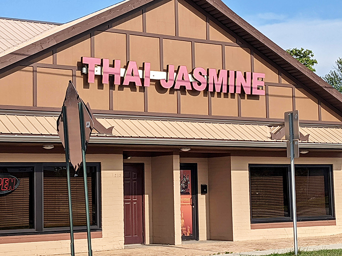 The unassuming exterior of Thai Jasmine might not stop traffic, but that pink sign promises culinary adventures that locals drive miles to experience.