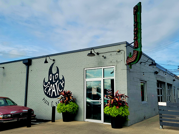 The unassuming exterior of Old Scratch Pizza belies the culinary magic happening inside. That flame logo isn't just for show&mdash;it's a promise of fire-kissed perfection.