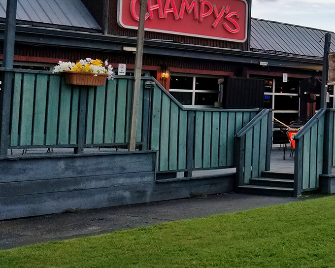 The bright red Champy's sign beckons like a lighthouse for the hungry, promising Southern comfort behind that cheerful turquoise fence.