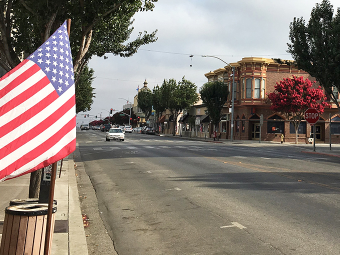 Downtown Hollister greets you with classic Americana charm &ndash; an American flag waves hello while historic buildings stand proudly against the California sky.