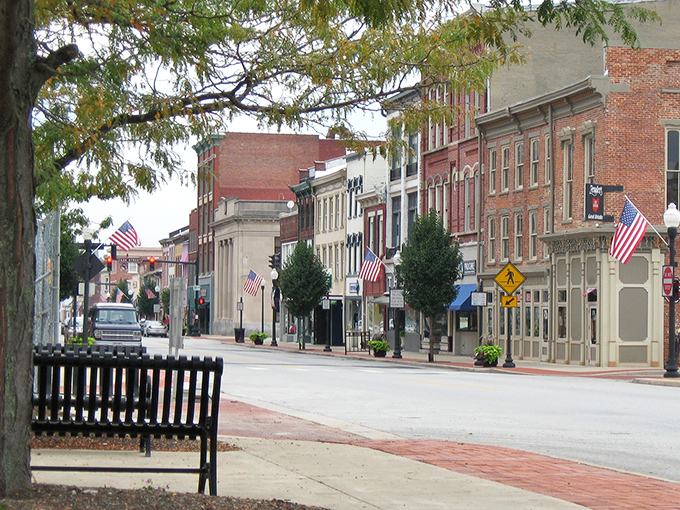 American flags flutter along brick-lined streets where neighbors still wave hello and parking doesn't require a second mortgage.