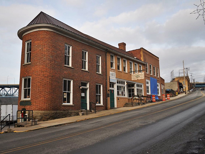 The distinctive round-cornered brick building anchors Brownsville's historic district, standing like a sentinel from another era against the quiet streetscape.