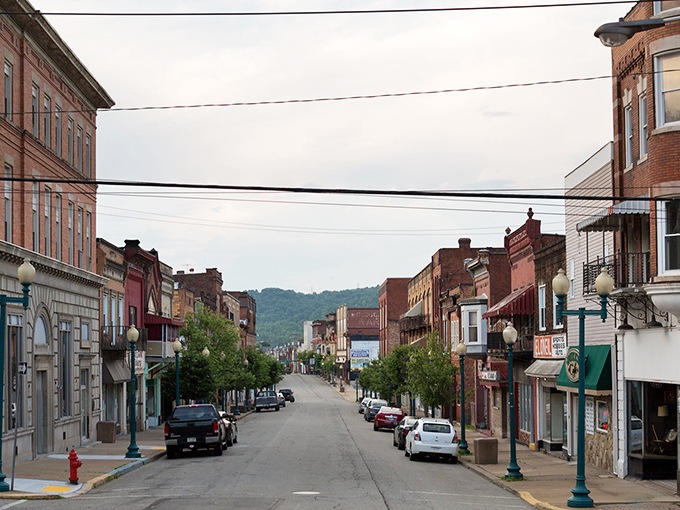 Donora's main street stretches toward green hills like a timeline connecting past and present, brick buildings standing sentinel to small-town stories.