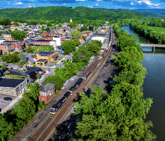 Huntingdon's aerial view reveals nature's perfect sandwich&mdash;town nestled between rolling mountains and the winding Juniata River. Small-town charm with big-time scenery.