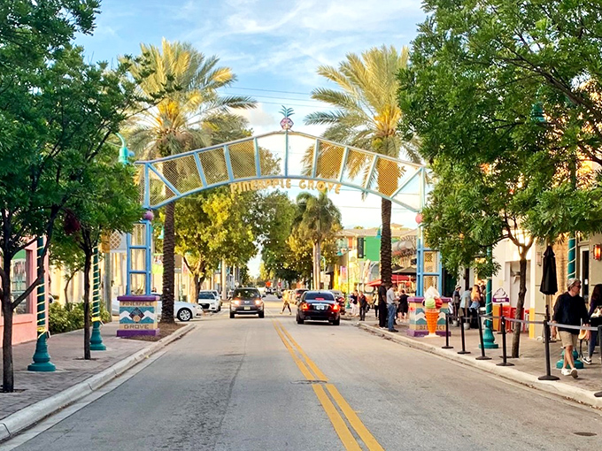 The iconic Pineapple Grove arch welcomes visitors to Atlantic Avenue, where palm trees stand like friendly sentinels guarding this slice of Florida paradise.