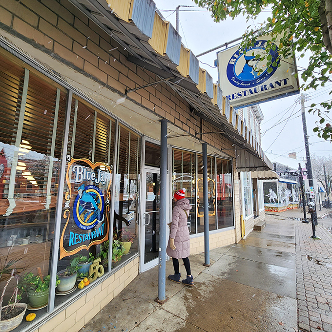 The iconic Blue Jay Restaurant storefront stands as a beacon of Cincinnati culinary tradition, its vintage sign promising comfort food treasures within.