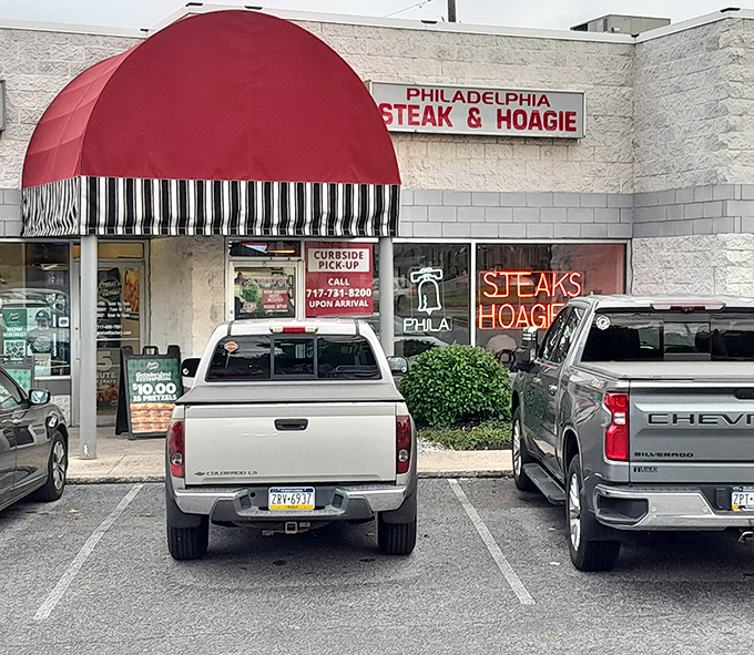 The iconic red awning of Philadelphia Steaks & Hoagies stands out like a beacon of hope for the hungry in Camp Hill. Cheesesteak salvation awaits!
