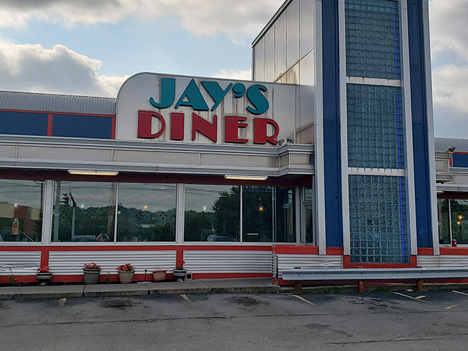 Jay’s Diner’s glowing red-and-blue neon sign shines like a beacon in Rochester, offering retro charm and round-the-clock comfort food.