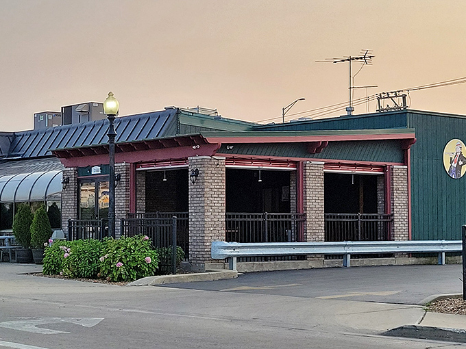The solarium-style exterior of Beggars Pizza catches the afternoon light, promising warmth inside even on chilly Illinois days.