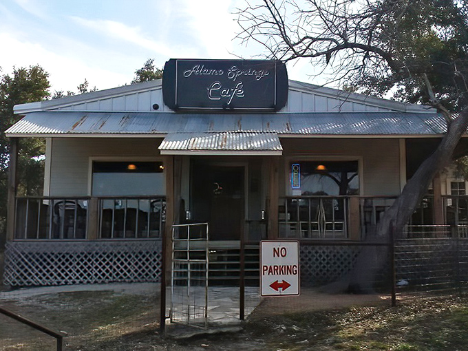 The unassuming exterior of Alamo Springs Caf&eacute; stands as a beacon for burger pilgrims. That metal roof has weathered countless Texas summers while sheltering burger perfection beneath.