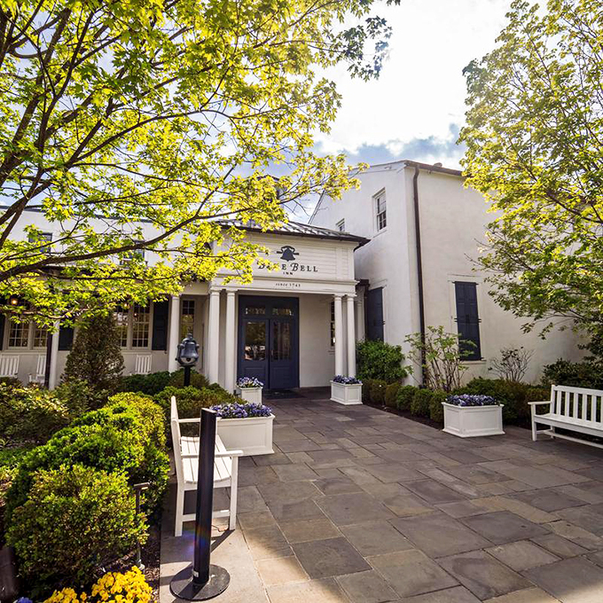 Stone walls that have witnessed centuries of celebrations frame the elegant outdoor dining area, where autumn colors provide nature's perfect backdrop.