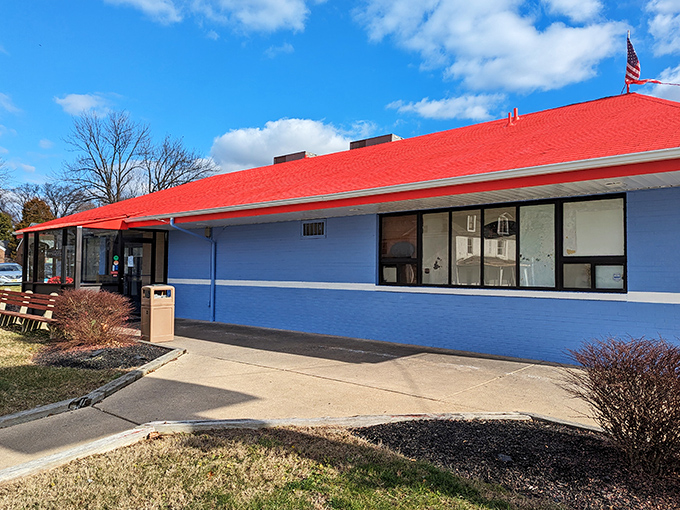 The classic blue-and-red exterior of Wilmington Diner stands like a beacon of breakfast hope on Marsh Road, promising comfort food salvation inside.