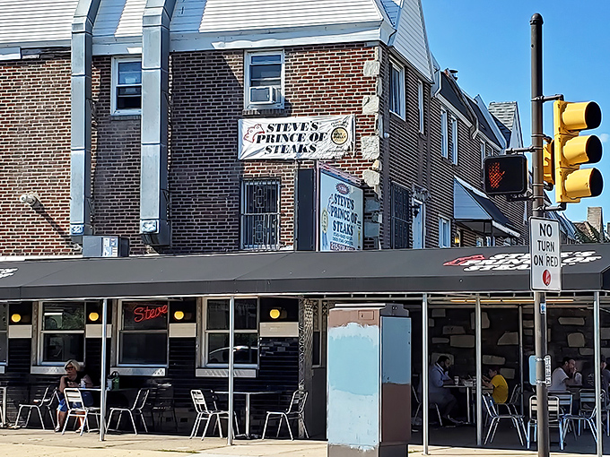 The corner brick building stands proudly at Bustleton Avenue, its modest signage a beacon for cheesesteak pilgrims seeking authentic Philadelphia flavor.