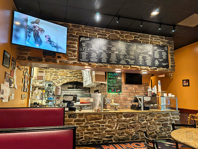 Stone walls and chalkboard menus create the perfect backdrop for culinary magic&mdash;where every pizza, calzone, and stromboli begins its journey from dough to delicious.