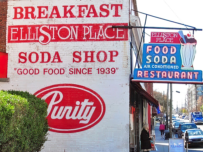 The vintage neon sign glows like a blue-and-red lighthouse, guiding food pilgrims to this temple of comfort cuisine in Nashville's urban landscape.