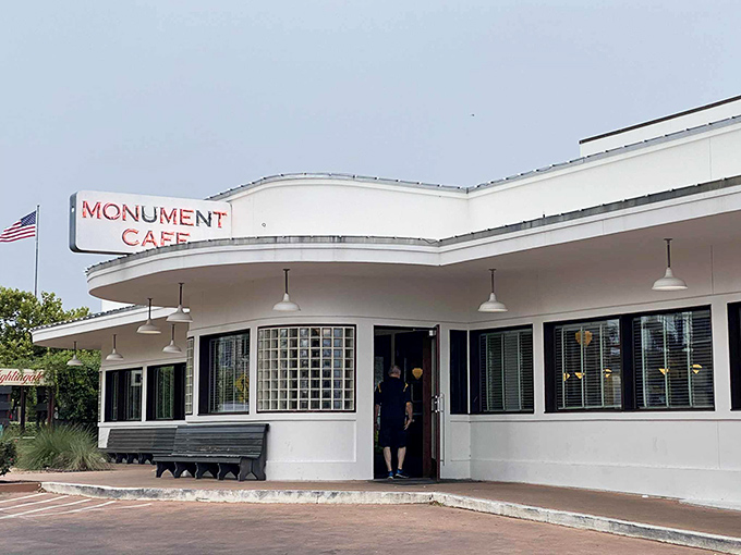 Art Deco dreams come alive at Monument Cafe's distinctive exterior. The curved white walls and bold red signage beckon hungry travelers like a culinary lighthouse in Georgetown.