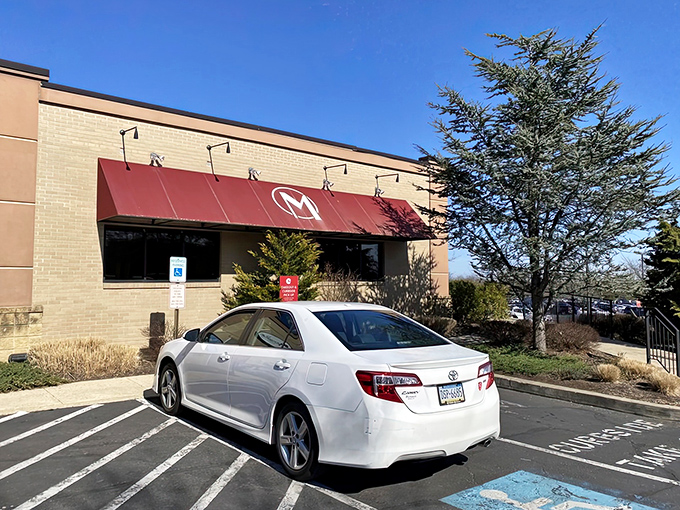 The iconic red awning with that distinctive "M" logo promises comfort food paradise in North Wales. Like a culinary lighthouse guiding hungry travelers home.